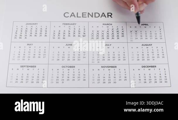 Person marking off dates on a calendar with a black marker. Useful for ...