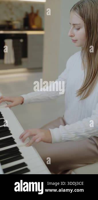 Teenage girl practicing piano at home. Study and learning development ...