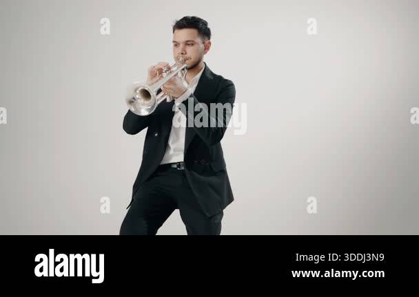 A male jazz singer plays the trumpet on a white background in a modern ...