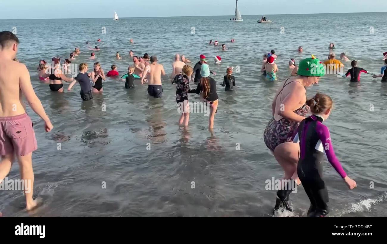 Swimmers in Ireland brave cold sea temperatures for New Year's charity ...