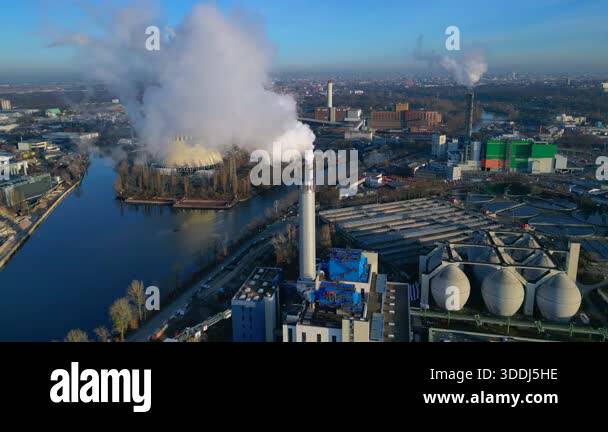 Aerial view of industrial heating plant with chimney releasing smoke ...