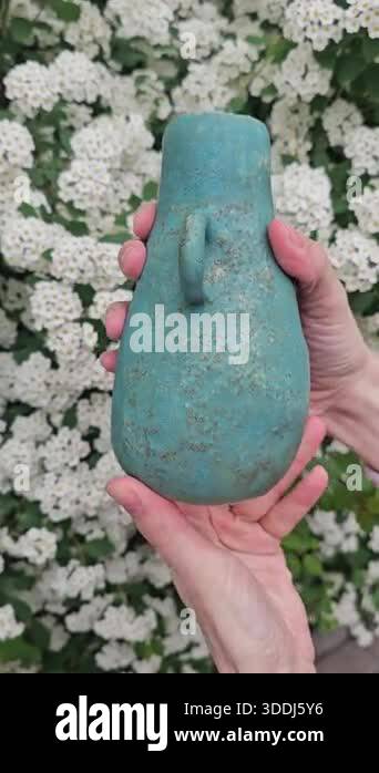 Close-up video of a small handmade ceramic vase made of chamotte clay ...