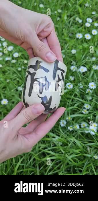 Video shows a small handmade ceramic bowl slowly rotated in hands ...