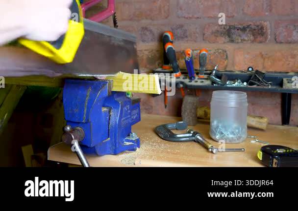Sawing wood on a workbench vice, woodworking, handyman or hobby concept ...