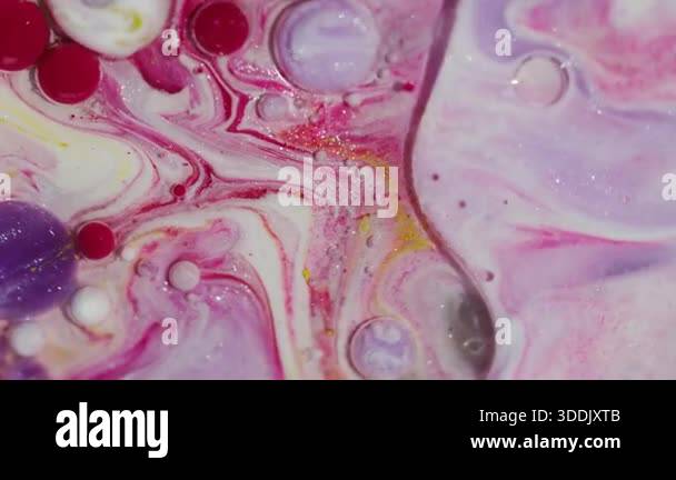 Shiny dye blend. Bubbles water. Defocused red purple orange color ink ...