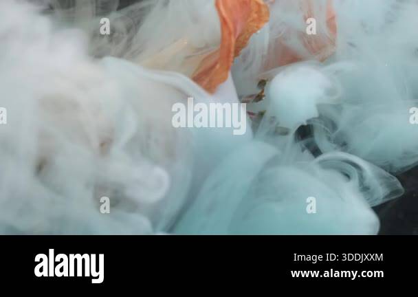 Vertical video. Color flower explosion. Mix paint fluid. Defocused blue ...