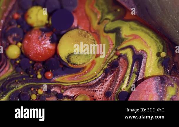 Paint liquid emulsion. Color bubbles. Defocused orange purple yellow ...