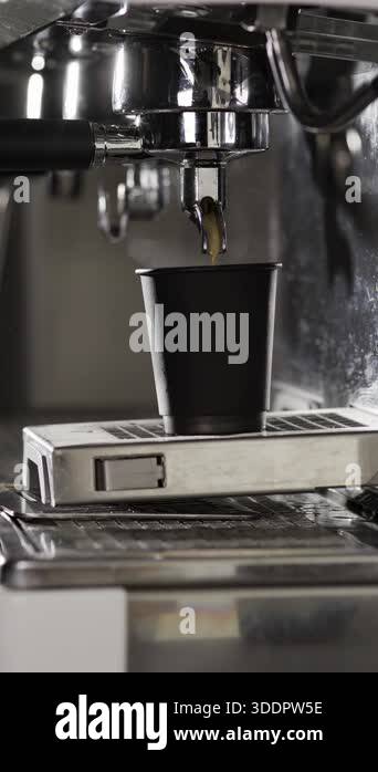Professional coffee machine making coffee espresso in paper glass ...
