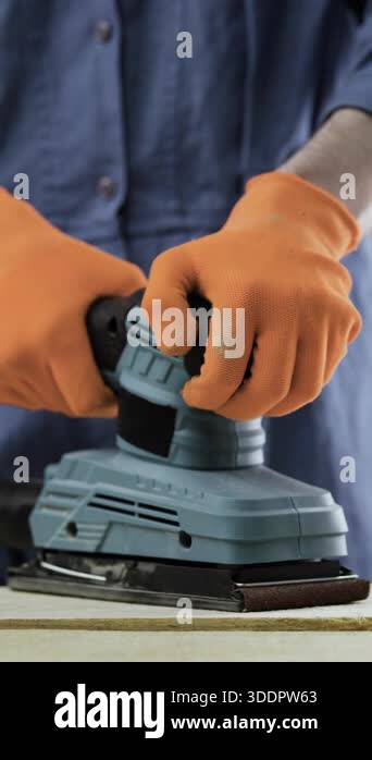 Grinding wood furniture with electric grinder machine. Woodwork and ...