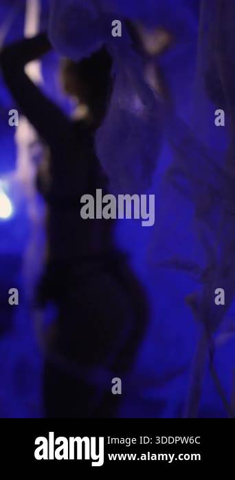 Dramatic silhouette of a woman dancer performing a mystical dance ...