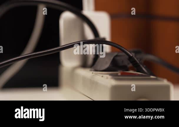 Energy efficiency. Man using electrical plug in outlet socket at home ...