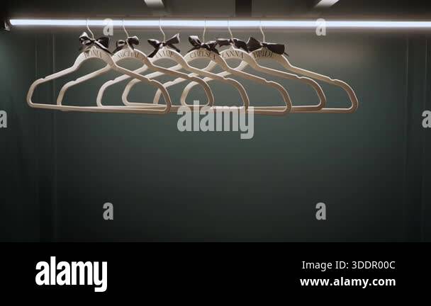 Empty Wooden Hangers Under LED Light, Row Of Unoccupied Hangers ...