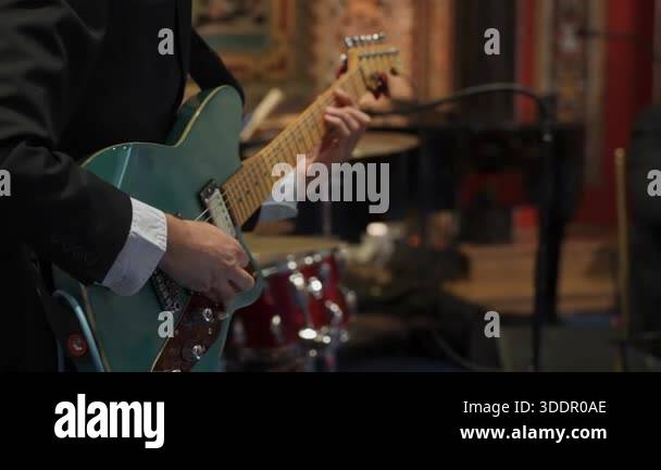 CloseUp Electric Guitar Lead In Club Setting, Suited Musician ...