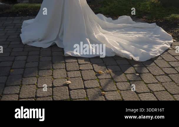 White Bridal Train On Cobblestone Walkway, Soft Tulle And Silk Pooling ...