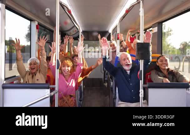 Multi ethnic group of passengers sitting on a public city bus. Happy ...