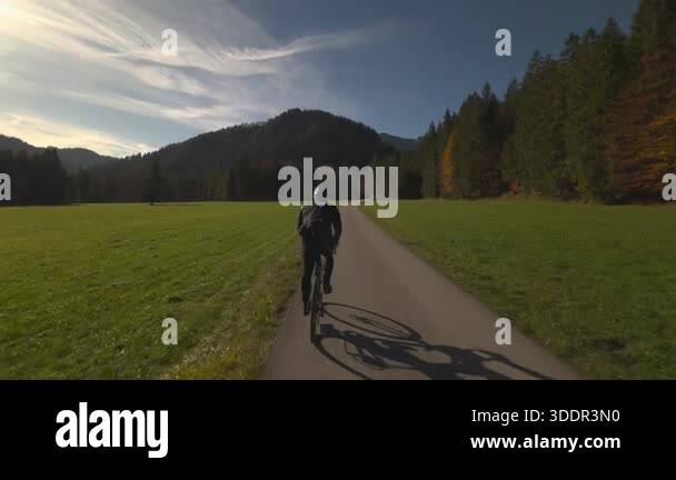 Cyclist rides along scenic paved bike path in Bavaria, Germany ...