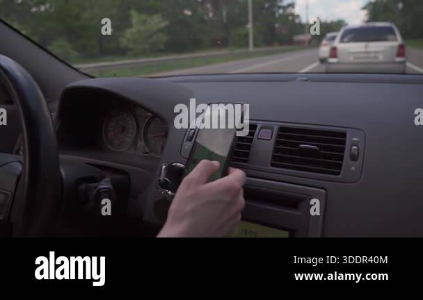 View from inside car on dashboard with smartphone. Mobile phone with ...