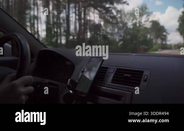 View from inside car on dashboard with smartphone. Mobile phone with ...