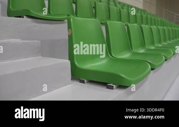 Crisp printed row number sticker placed on bright plastic seat. Soft ...