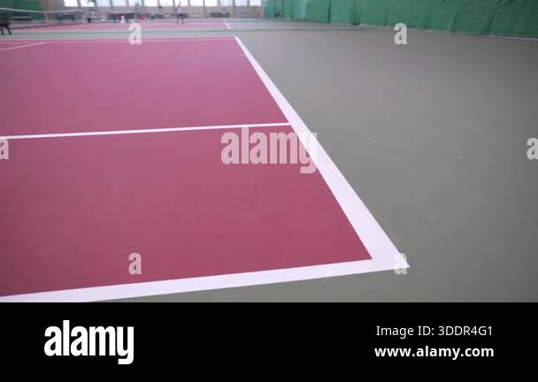 Clean tennis markings stretch across gym floor forming sharp lines ...