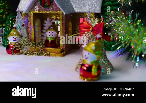 A house with a snowman and a Christmas tree on the porch, surrounded by ...