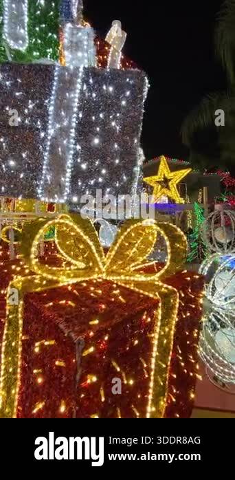A close view shows a giant present wrapped in tinsel with a glowing ...
