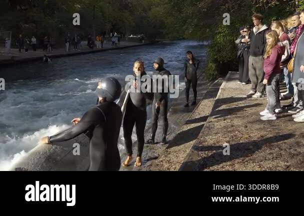 October 12, 2025. Munich, Germany. The Eisbach in Munich combines city ...