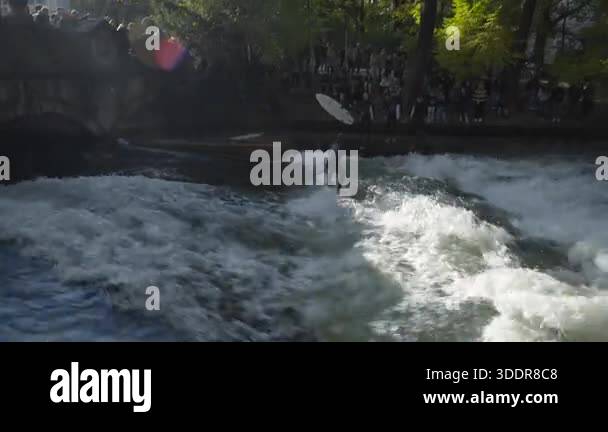 October 12, 2025. Munich, Germany. Surfers at the Eisbach wave in ...