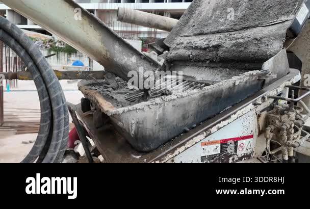 wet concrete pouring from a mixer chute into a pump hopper Stock Video ...