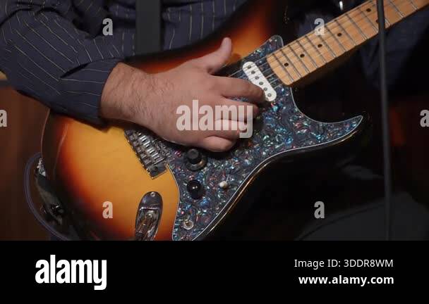 CloseUp Electric Guitar Hand Strumming Sunburst Body In Dim Studio ...