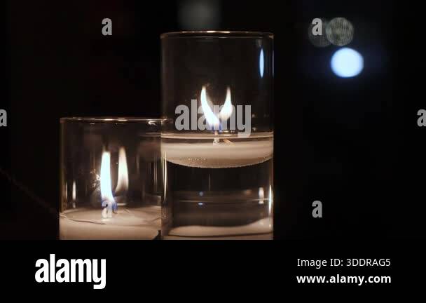Two Glass Votives With Floating Candles, Warm Amber Flame Dancing Over ...