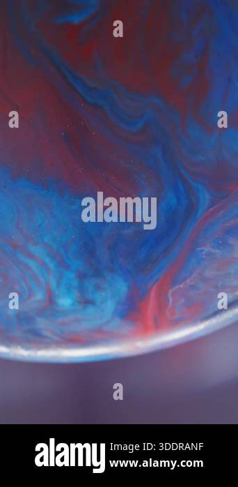 Vertical video. Acrylic spill. Blur paint swirl. Red blue dye mixing ...