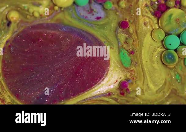 Shiny splatter. Ink oil mix. Defocused yellow green red color sparkling ...