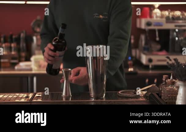 Bartender work. Cocktail drink. Professional mixologist using metal ...