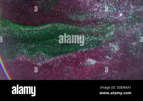 Rainbow ink splash. Glitter fluid. Defocused red green colorful paint ...