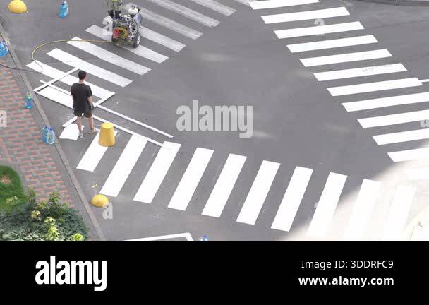 Applying road markings intersection,crossway. Paint a pedestrian ...