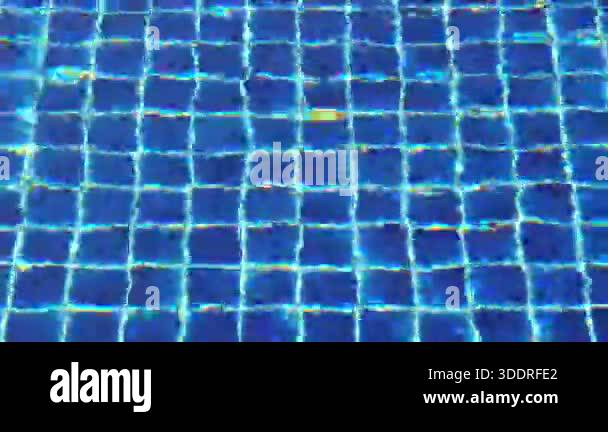 Blue pool tiles appear beneath rippling water with light reflections ...