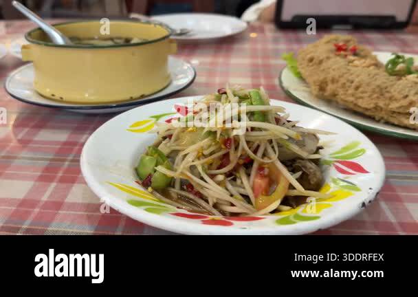 Som tam, grilled chicken, fried catfish, and crispy pork are served on ...