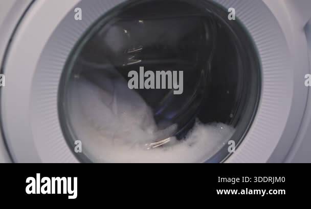 The drum of a washing machine spinning during the wash cycle. Laundry ...