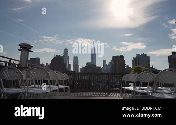 Sunlit Terrace With Folding Chairs And City Skyline Backdrop, Bright ...