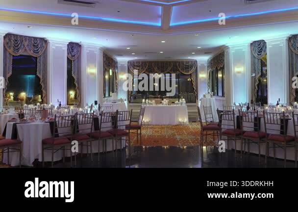 Empty Hotel Ballroom With Blue Uplighting, Round Tables Dressed In ...