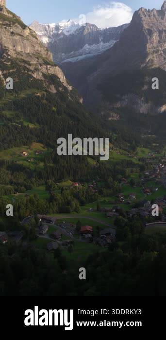 Aerial drone view at sunset over Grindelwald, showing the alpine ...