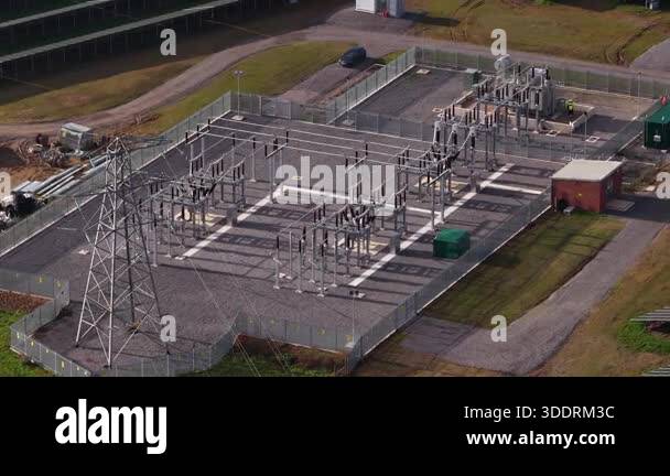 Aerial drone video of a high-voltage electrical substation, showcasing ...