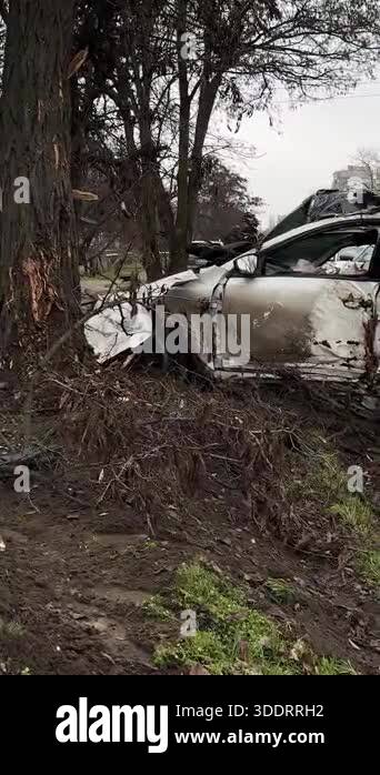A white passenger car sustains extensive damage after a serious traffic ...