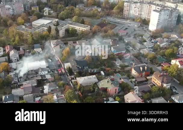 A fire in a private residential area: thick white smoke rises from the ...