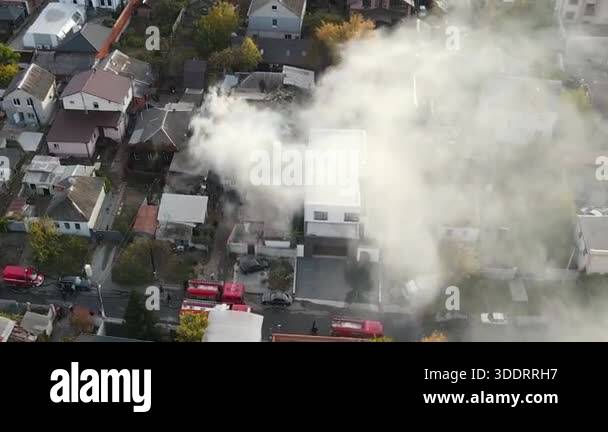 A fire in a private residential area: thick white smoke rises from the ...