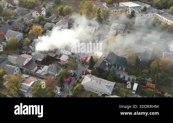 A fire in a private residential area: thick white smoke rises from the ...