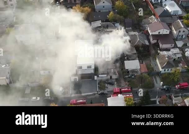 A fire in a private residential area: thick white smoke rises from the ...