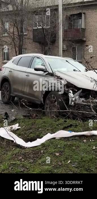 The aftermath of a severe accident: a gray SUV with catastrophic damage ...