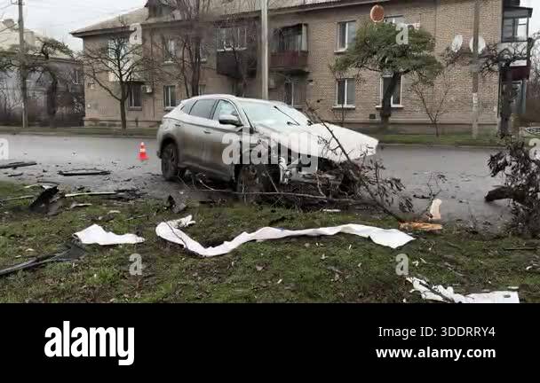 The aftermath of a severe accident: a gray SUV with catastrophic damage ...